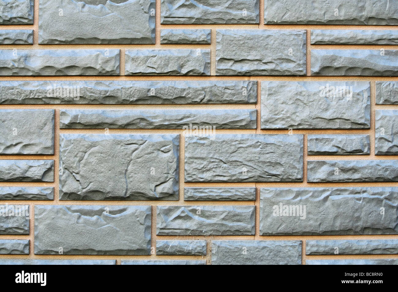 Stone wall of a stacked brick facade Stock Photo - Alamy