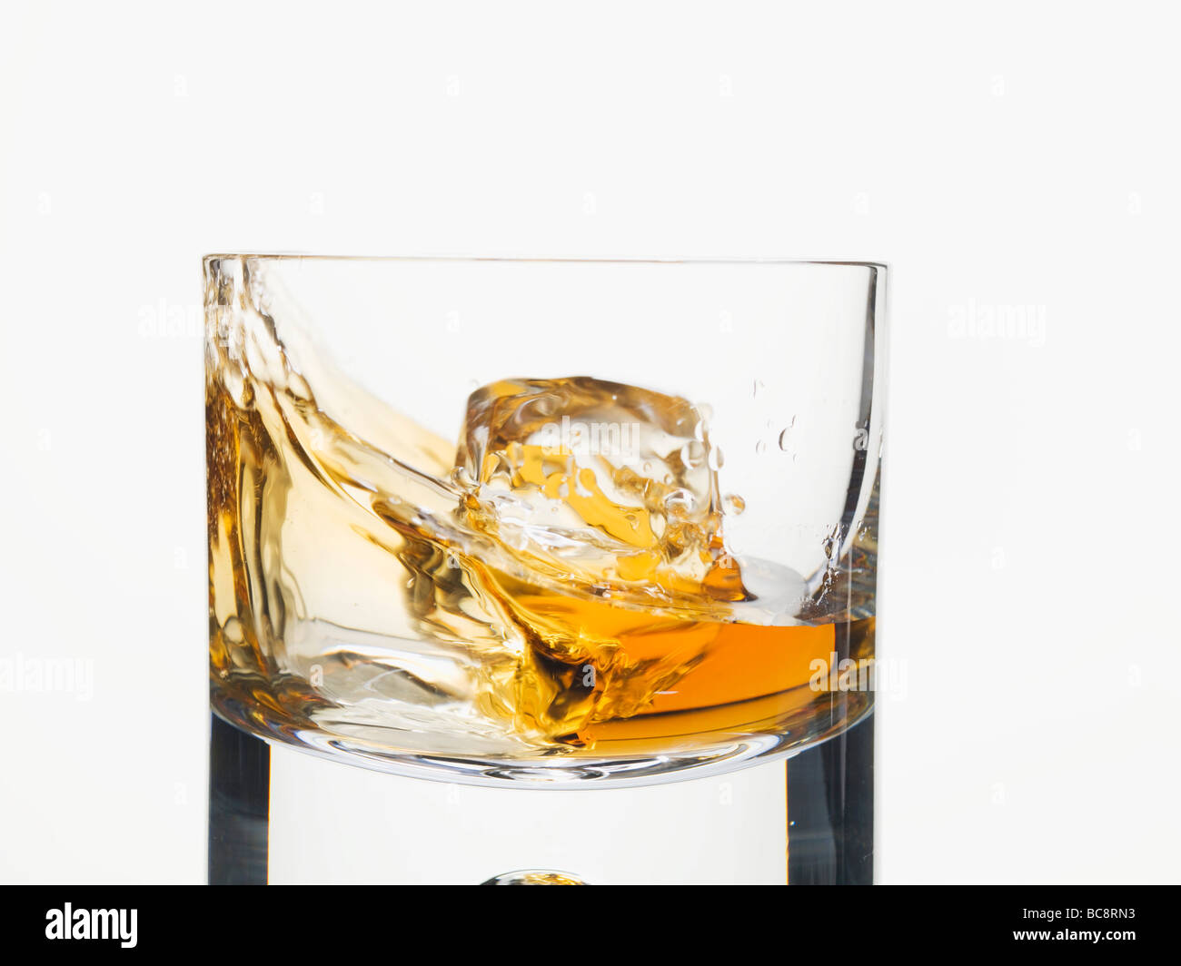 Whisky swirling in a glass Stock Photo - Alamy