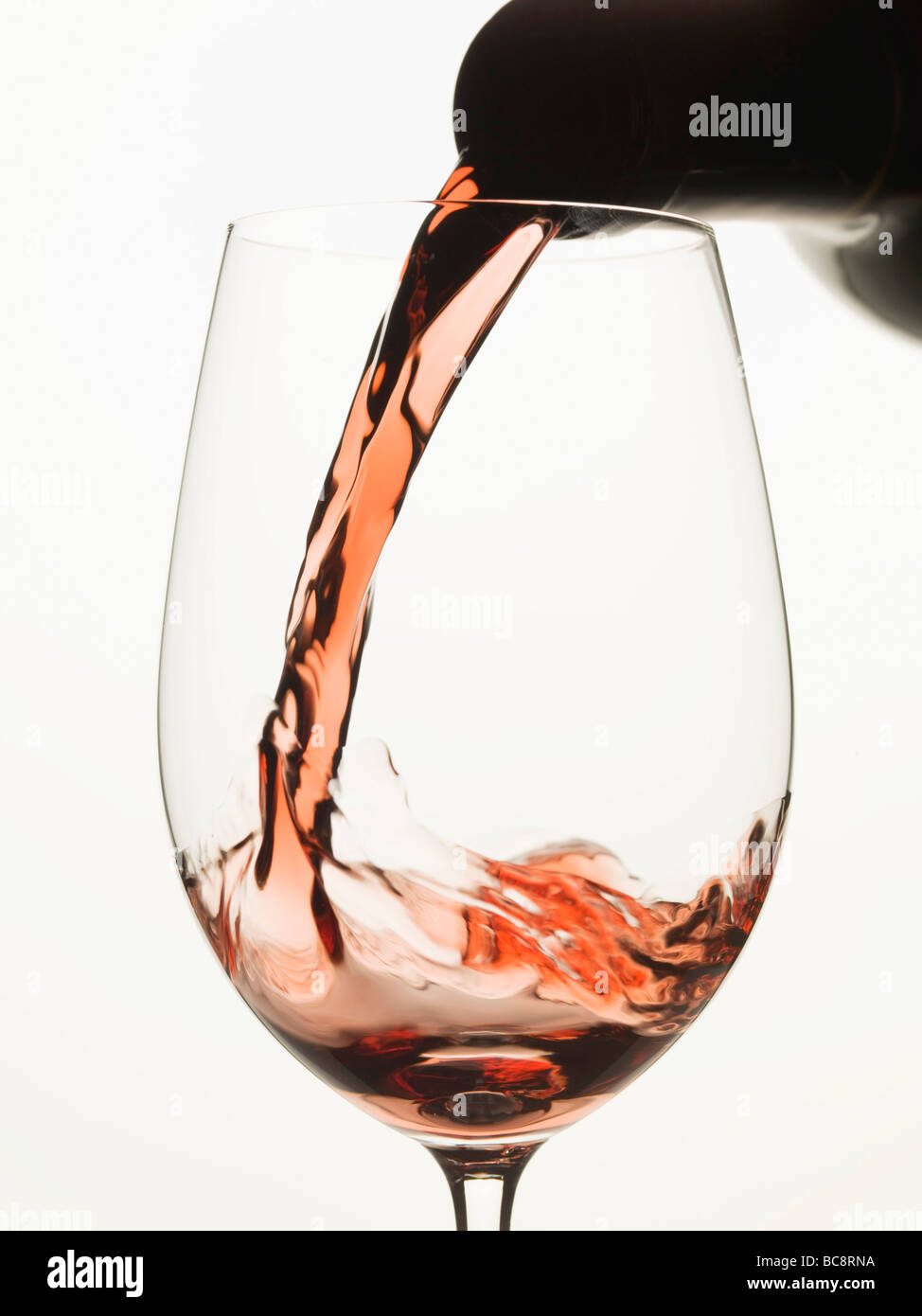 Pouring red wine into a glass Stock Photo - Alamy