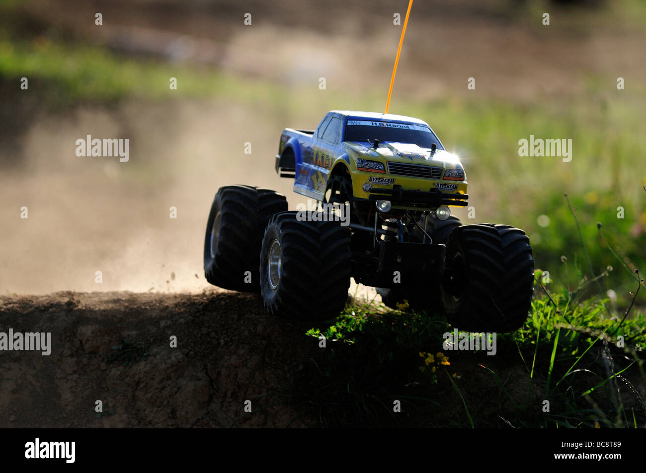 Tamiya toy radio controlled Monster Truck speeding and jumping Stock ...