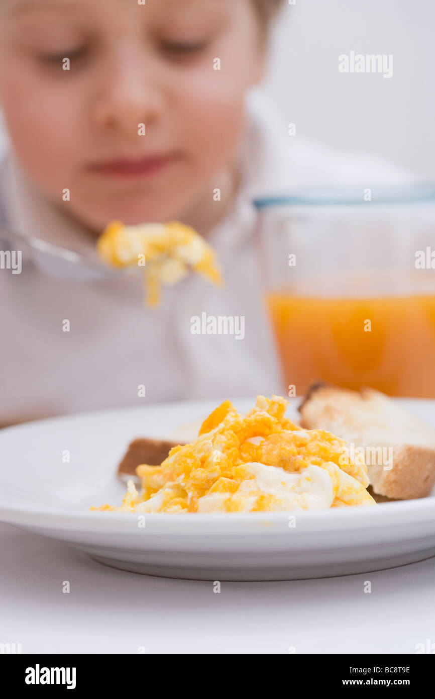 Little boy eating scrambled egg Stock Photo - Alamy