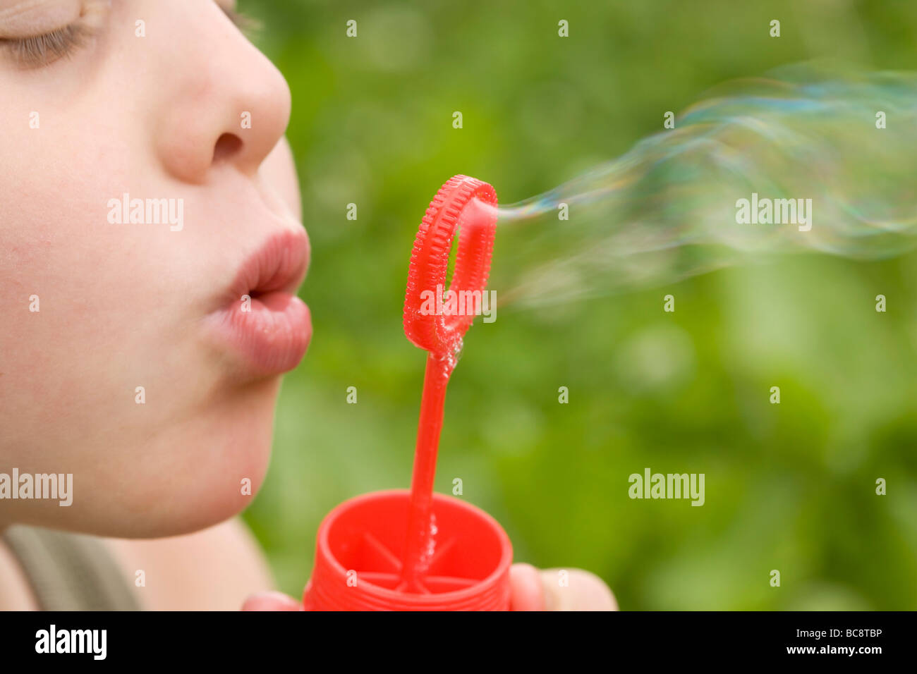 Child blowing bubbles Stock Photo - Alamy