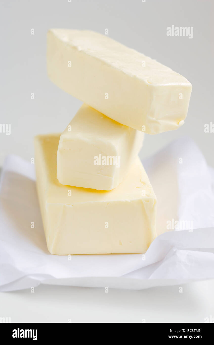 Blocks of butter, stacked, on paper Stock Photo - Alamy
