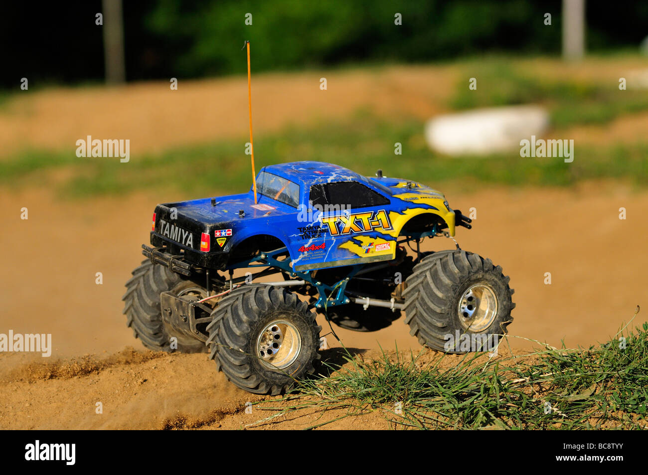 Tamiya toy radio controlled Monster Truck speeding and jumping Stock ...
