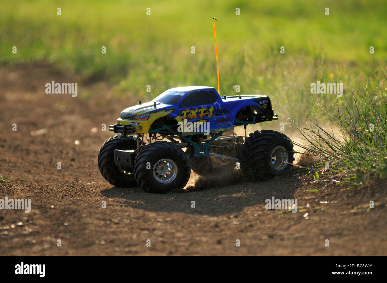 Tamiya toy radio controlled Monster Truck speeding and jumping Stock ...
