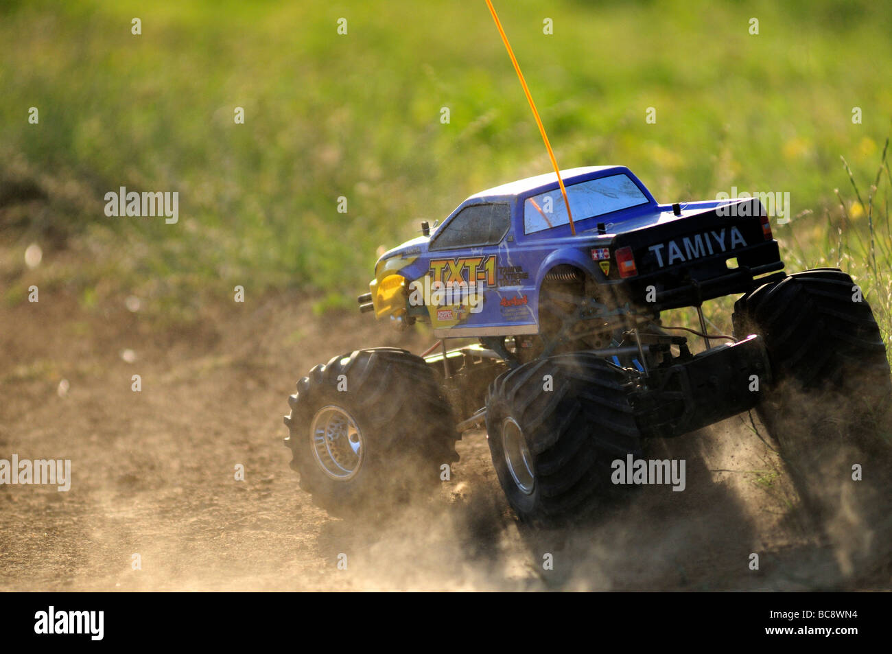 Tamiya toy radio controlled Monster Truck speeding and jumping Stock ...