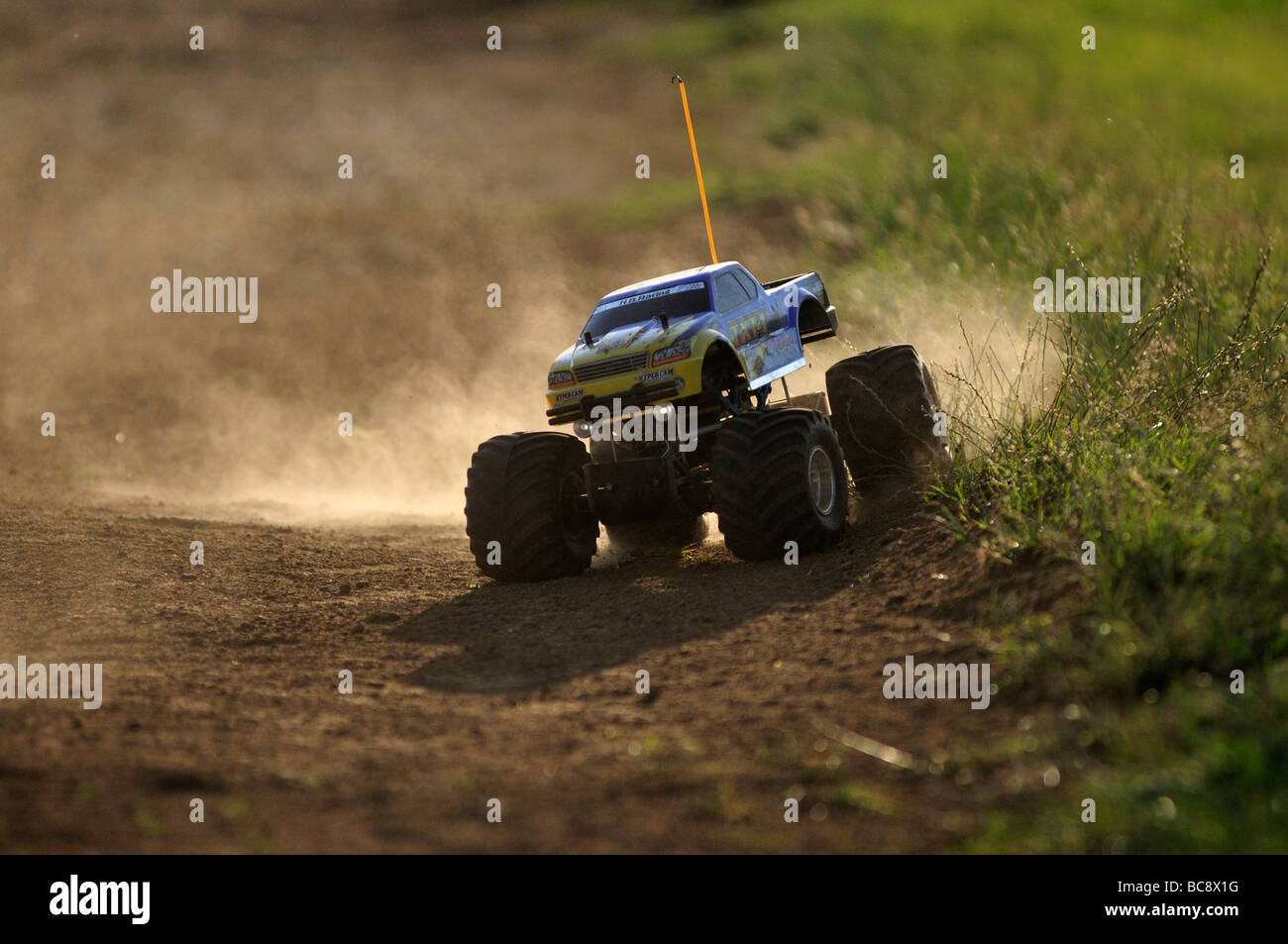 Tamiya toy radio controlled Monster Truck speeding and jumping Stock ...