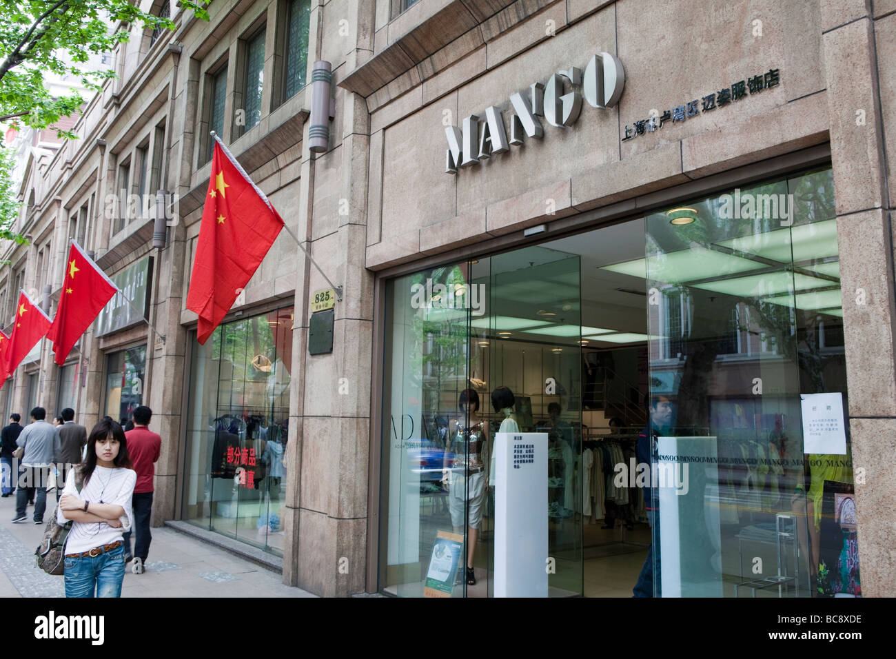 A woman walks past a Mango store in Shanghai, China Stock Photo - Alamy
