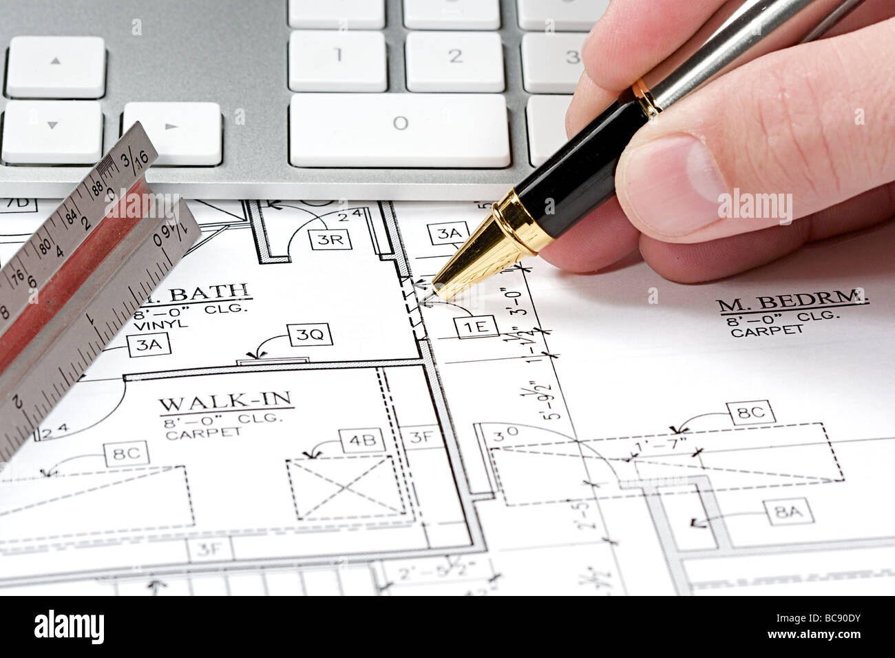 Modern architect using a CAD blueprint and a computer Stock Photo - Alamy