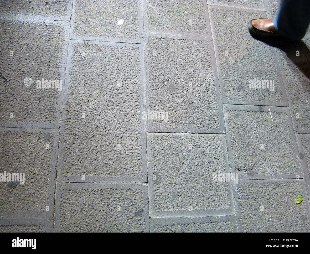 one single person walking on city street pavement at night Stock Photo ...