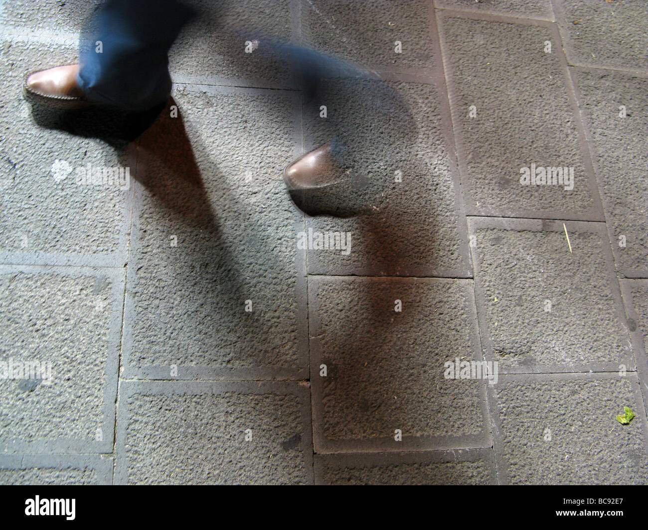 one single person walking on city street pavement at night Stock Photo ...