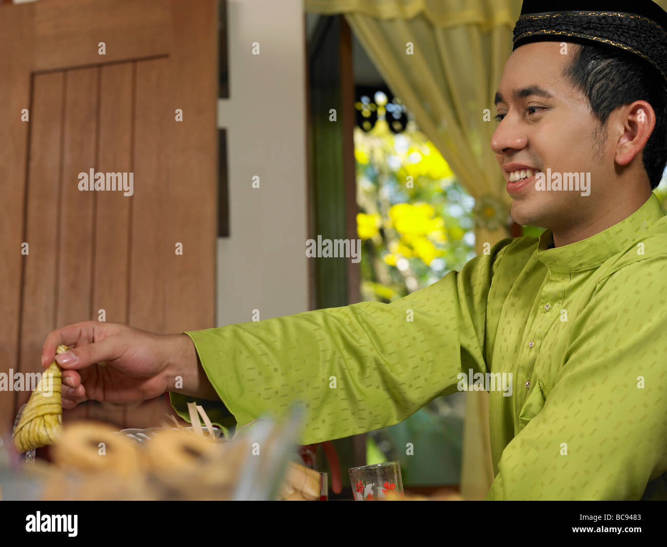 man offering festive food Stock Photo - Alamy