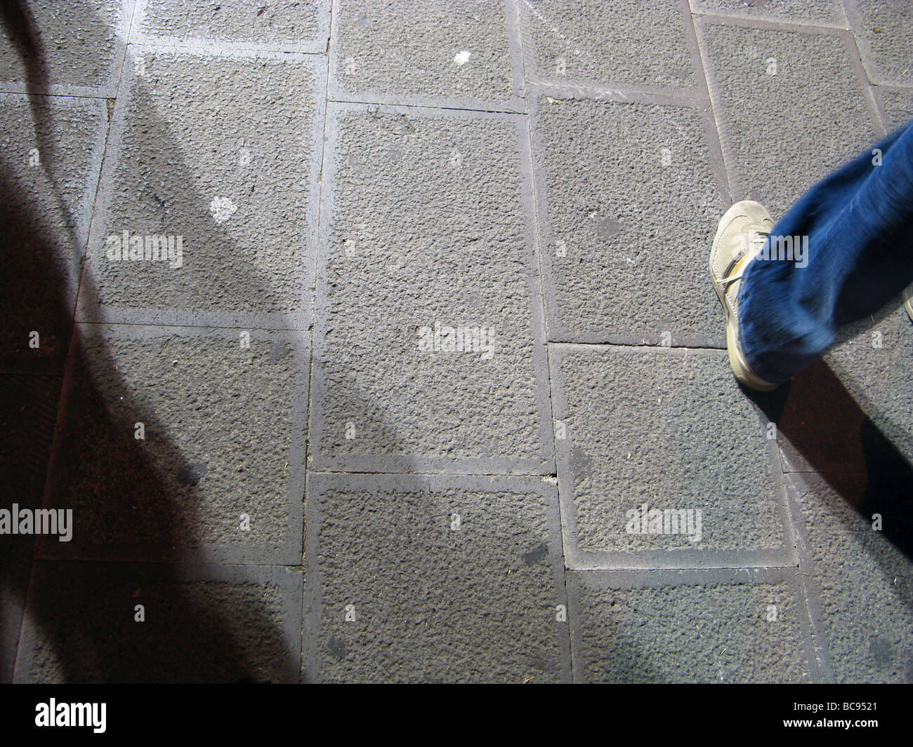 one single person walking on city street pavement at night Stock Photo ...