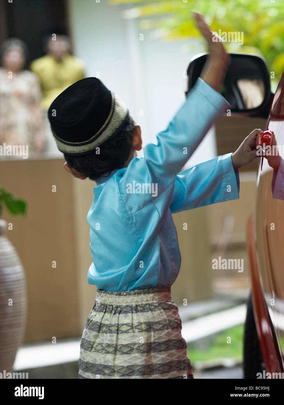 boy waiving hand to the grandparent Stock Photo - Alamy