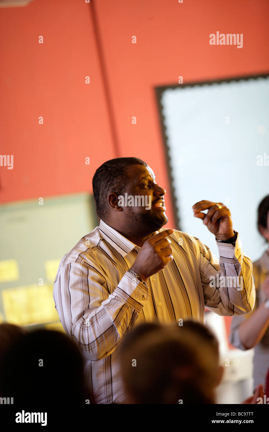 Teacher singing a song in a classroom Stock Photo - Alamy