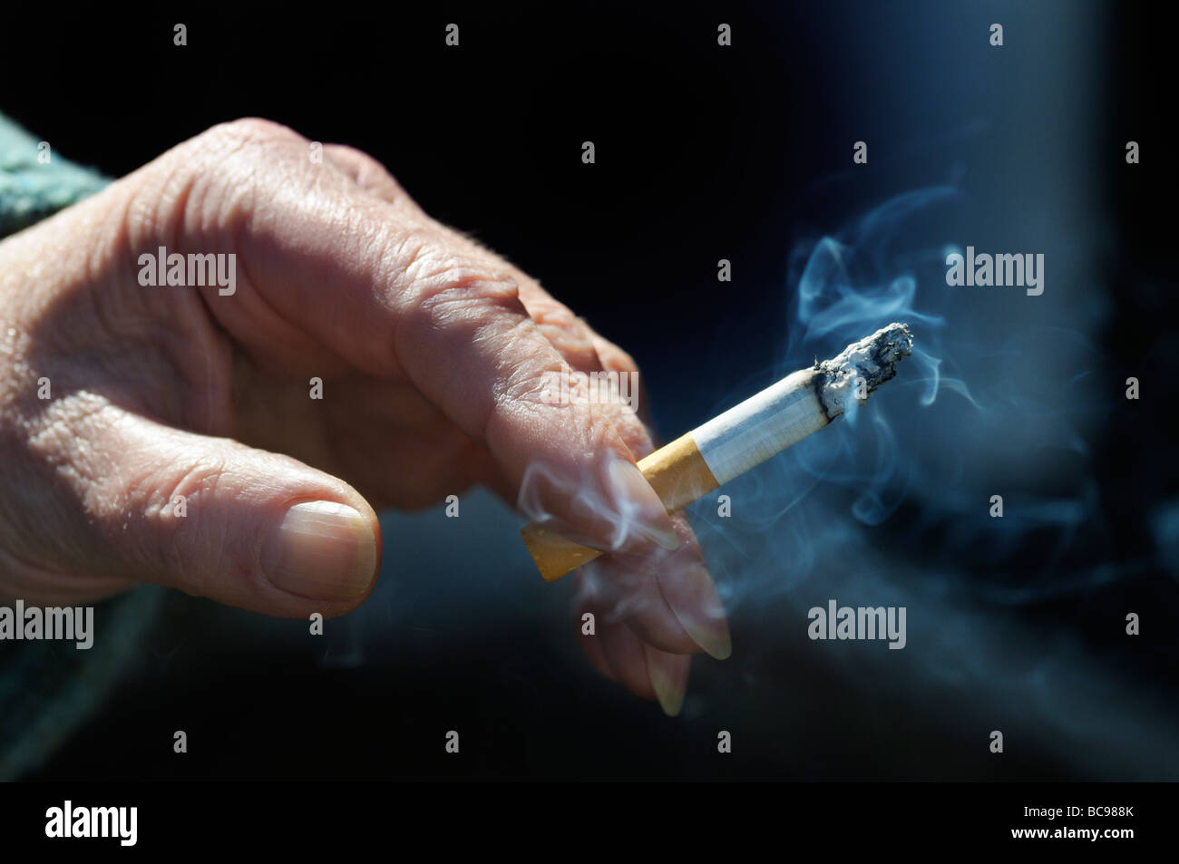 Hand holding lit cigarette smoking hi-res stock photography and images ...