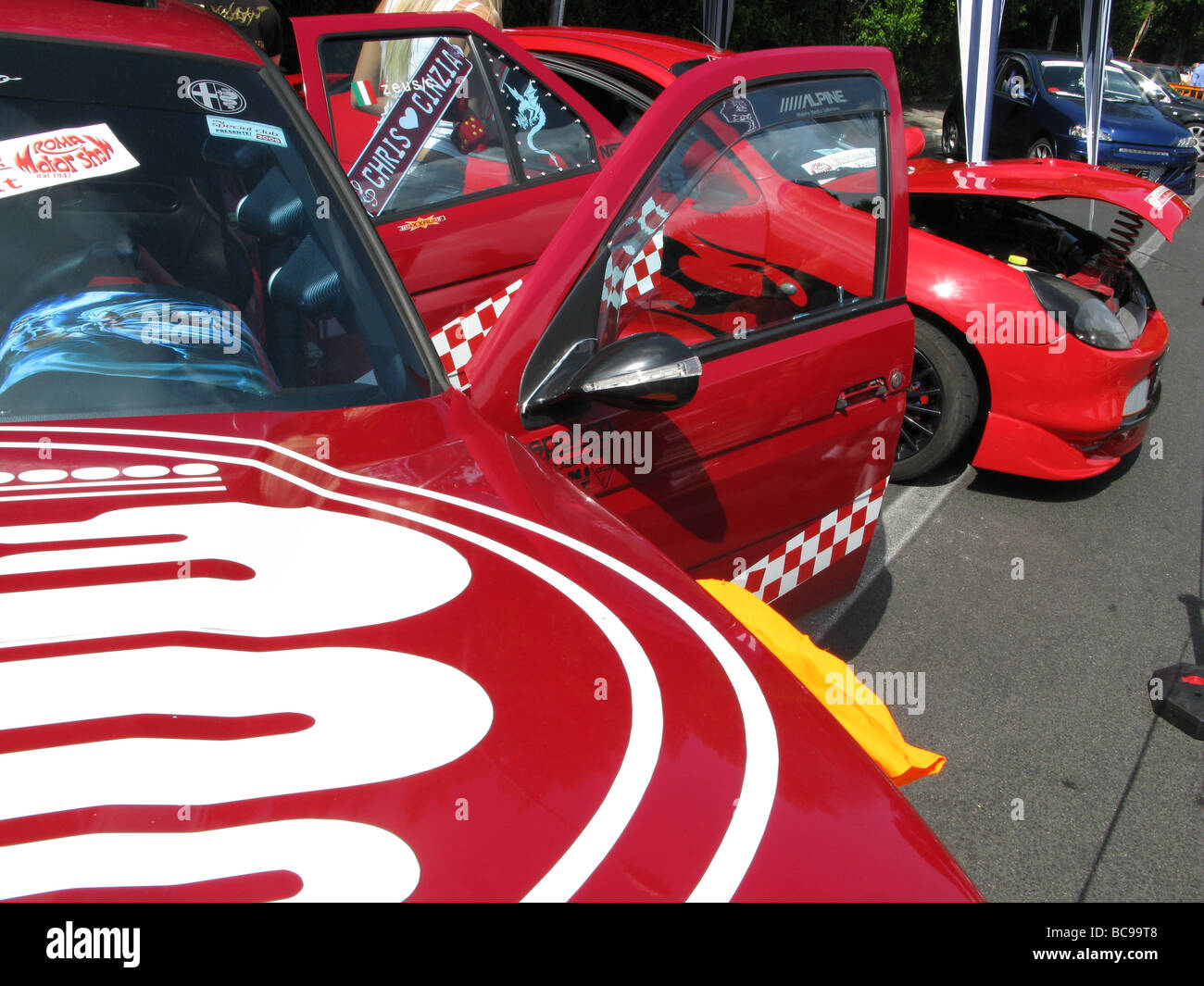 two custom red sports cars at motor show display event Stock Photo - Alamy
