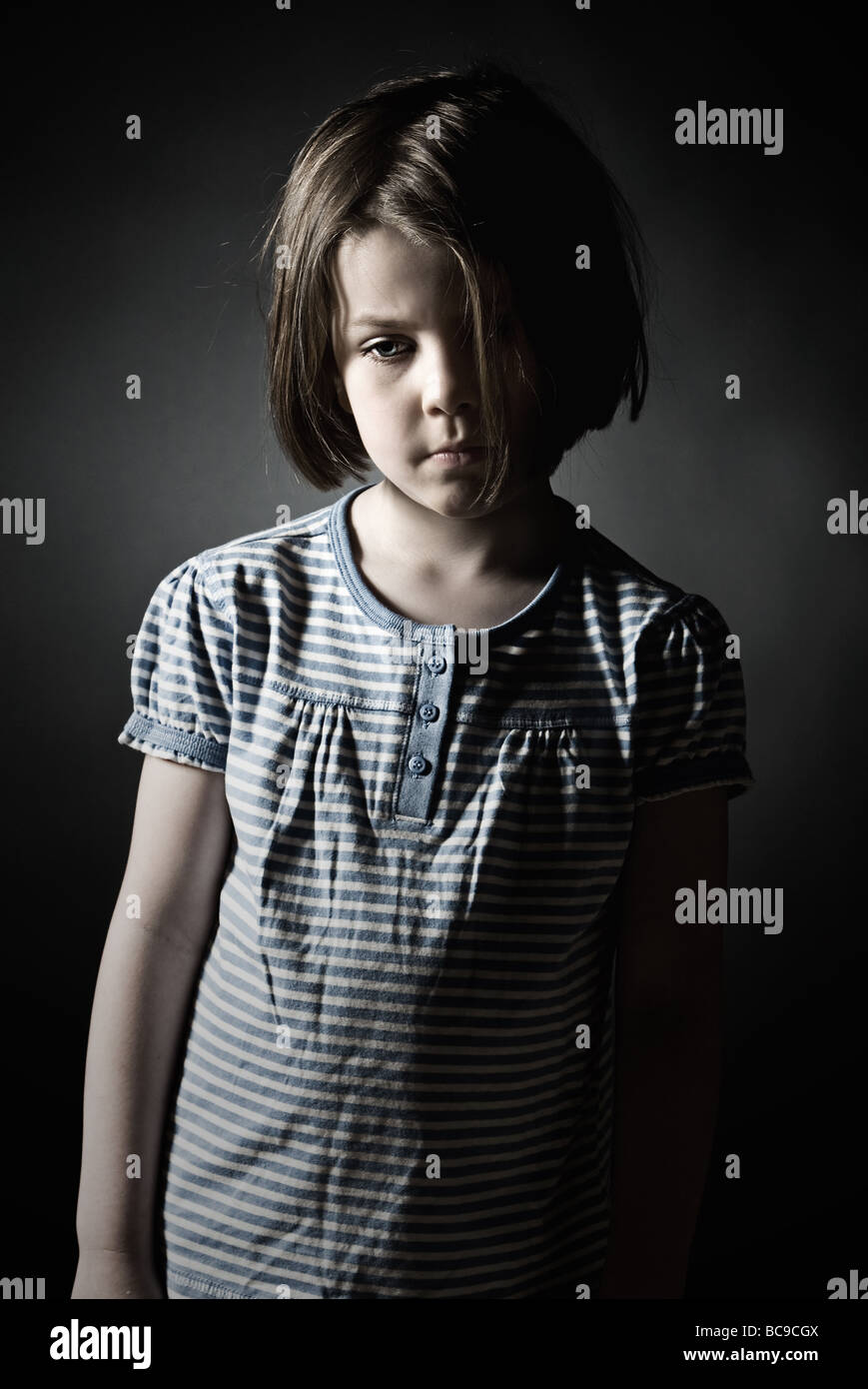 Low Key Shot of a Sad Little Girl against Grey Background Stock Photo ...