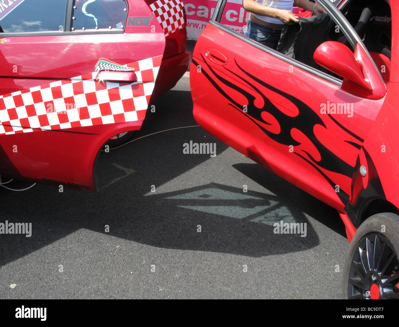 two custom red sports cars at motor show display event Stock Photo - Alamy