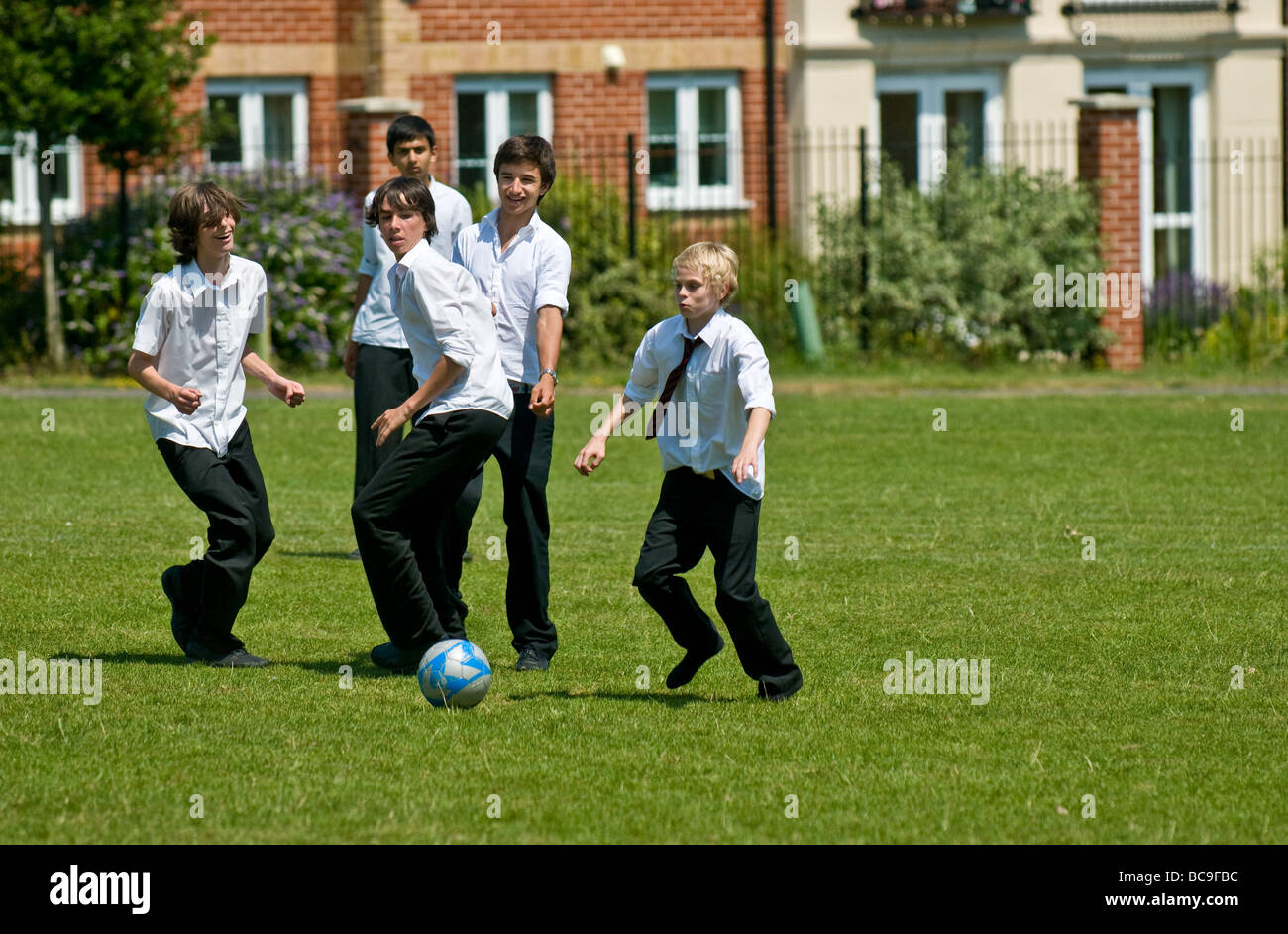 Schoolboys playing football during their lunchbreak. Soccer Stock Photo ...
