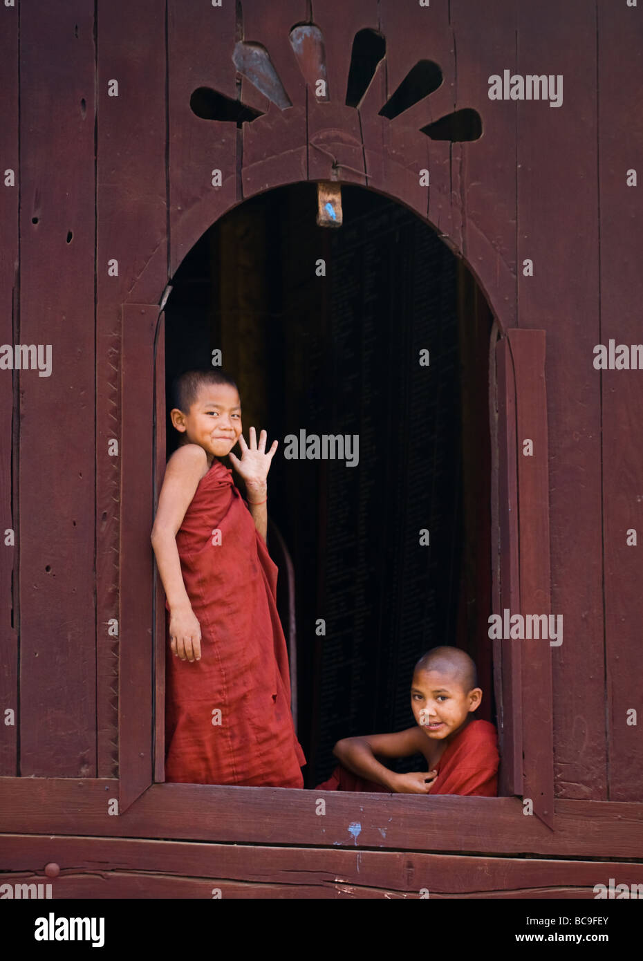 Young novice monks greeting from the oval windows of the Shwe Yaungshwe ...
