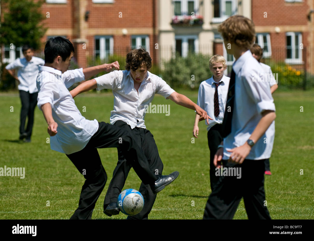 Schoolboys playing football during their lunchbreak. Soccer Stock Photo ...