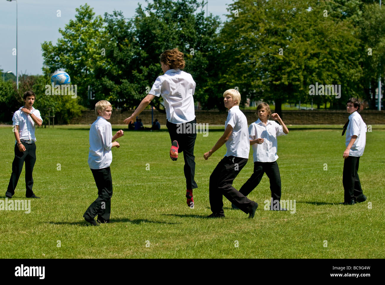 Schoolboys playing football during their lunch break. Soccer Stock ...