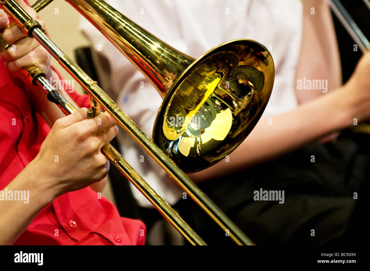 A student playing the trombone. Photo by Gordon Scammell Stock Photo ...