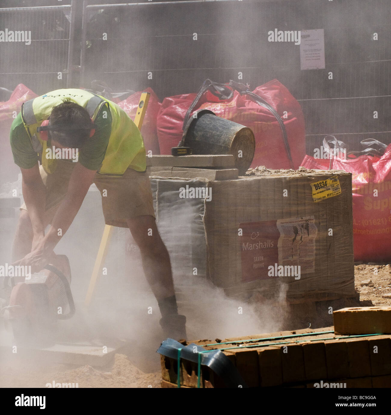 A building worker working in a cloud of dust. Photo by Gordon Scammell ...