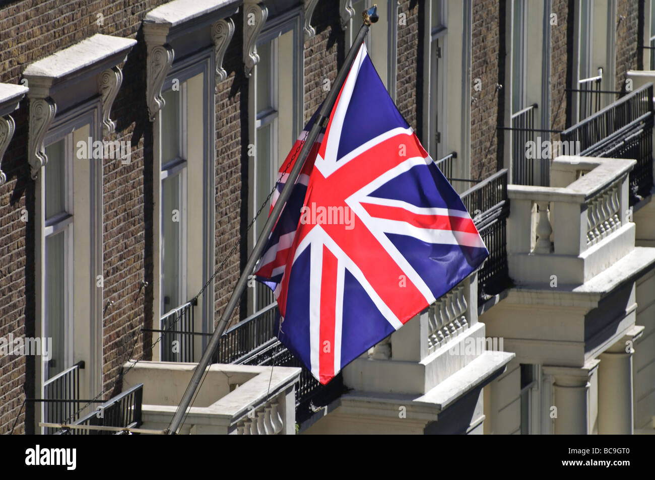 The Union Jack flag flies high over a typically London street scene ...