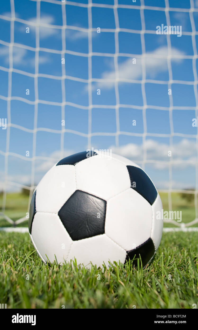 Close up of football in goal net Stock Photo - Alamy