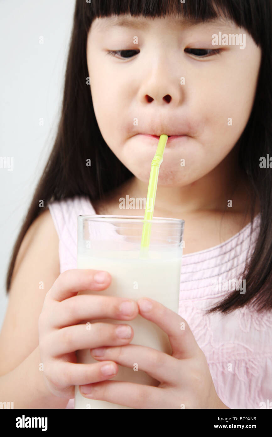 little girl drinking milk or soya drink with straw Stock Photo - Alamy