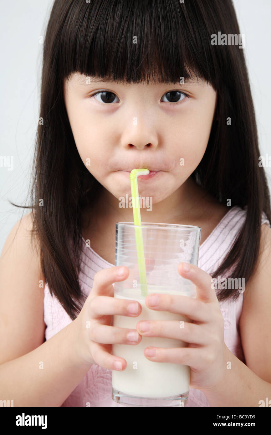 little girl drinking milk or soya drink with straw Stock Photo - Alamy