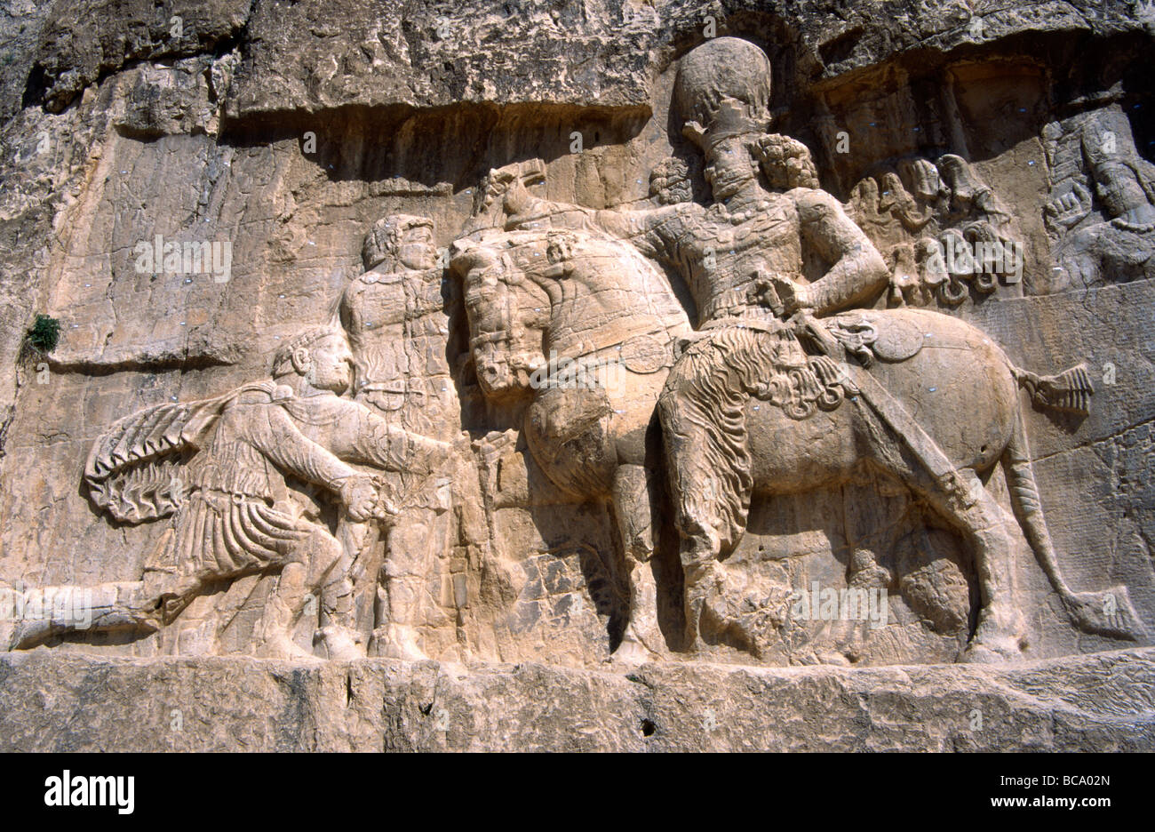 Rock relief depicting Shapur I on horseback on next to the tomb of ...