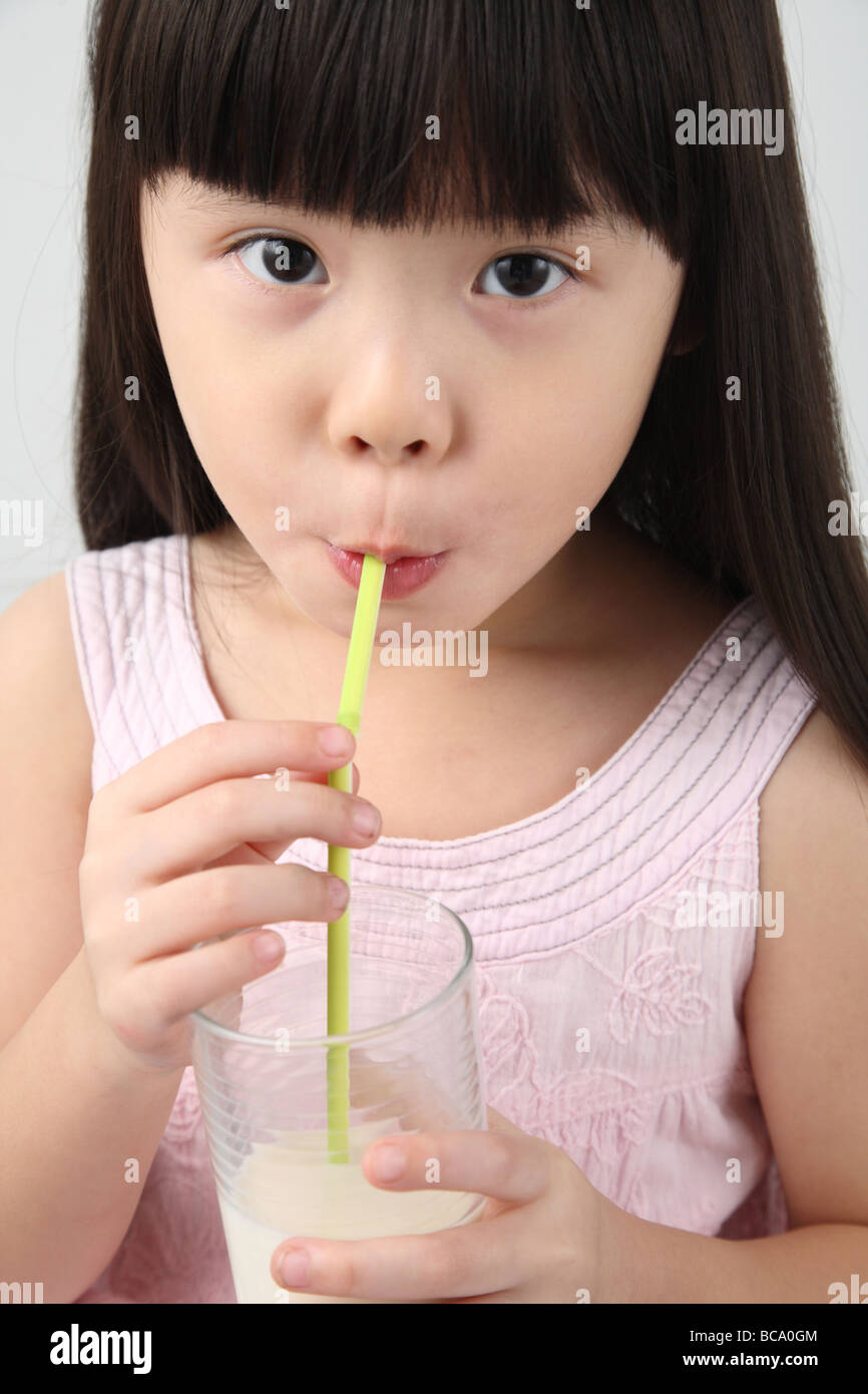little girl drinking milk or soya drink with straw Stock Photo - Alamy