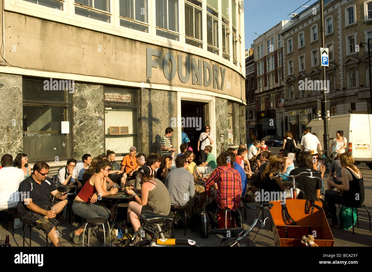 Alfresco drinkers outside The Foundry bar in Shoreditch, London, EC2 ...