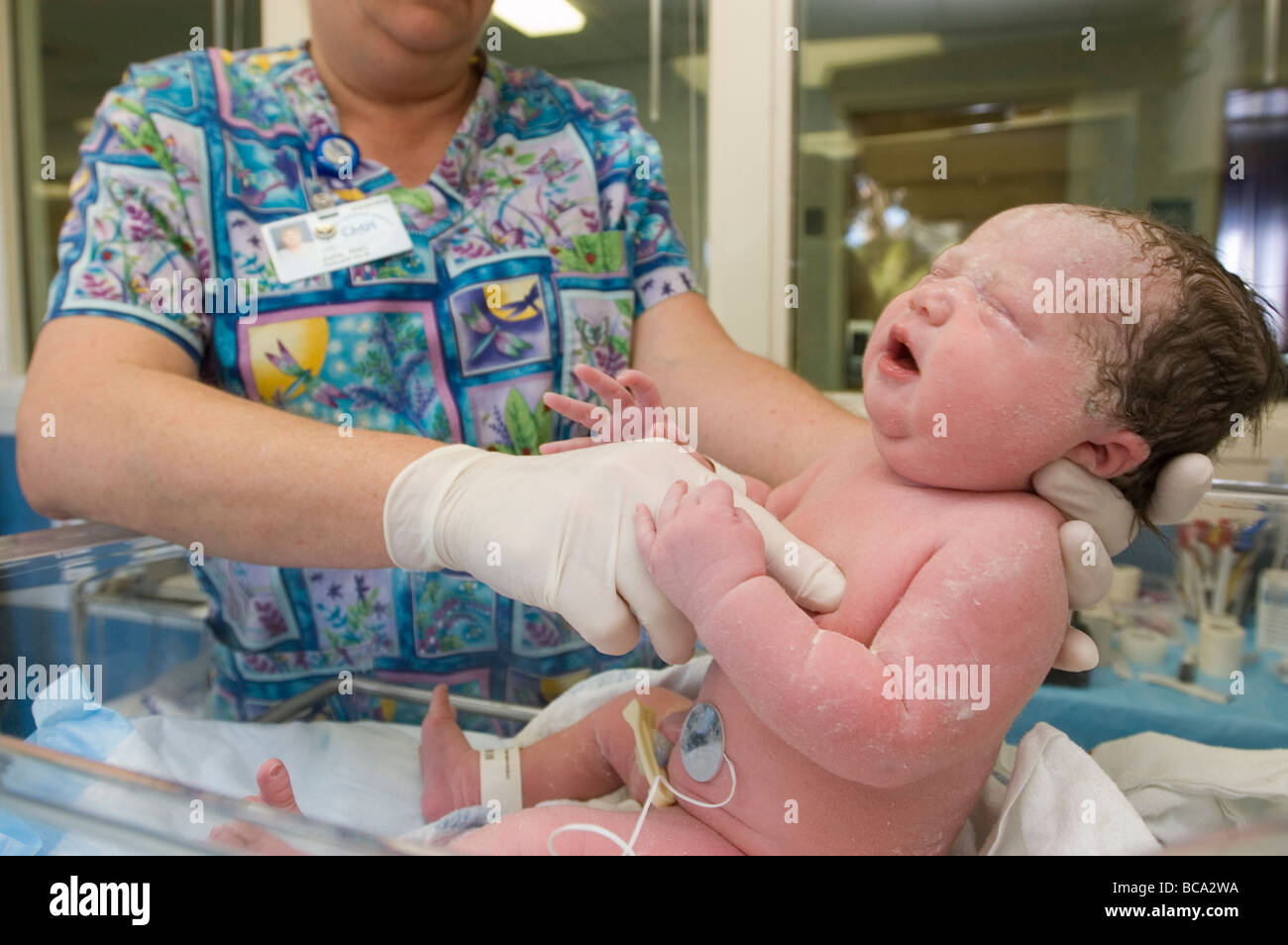 Closeup of a newborn baby girl being examined by a nurse Stock Photo ...