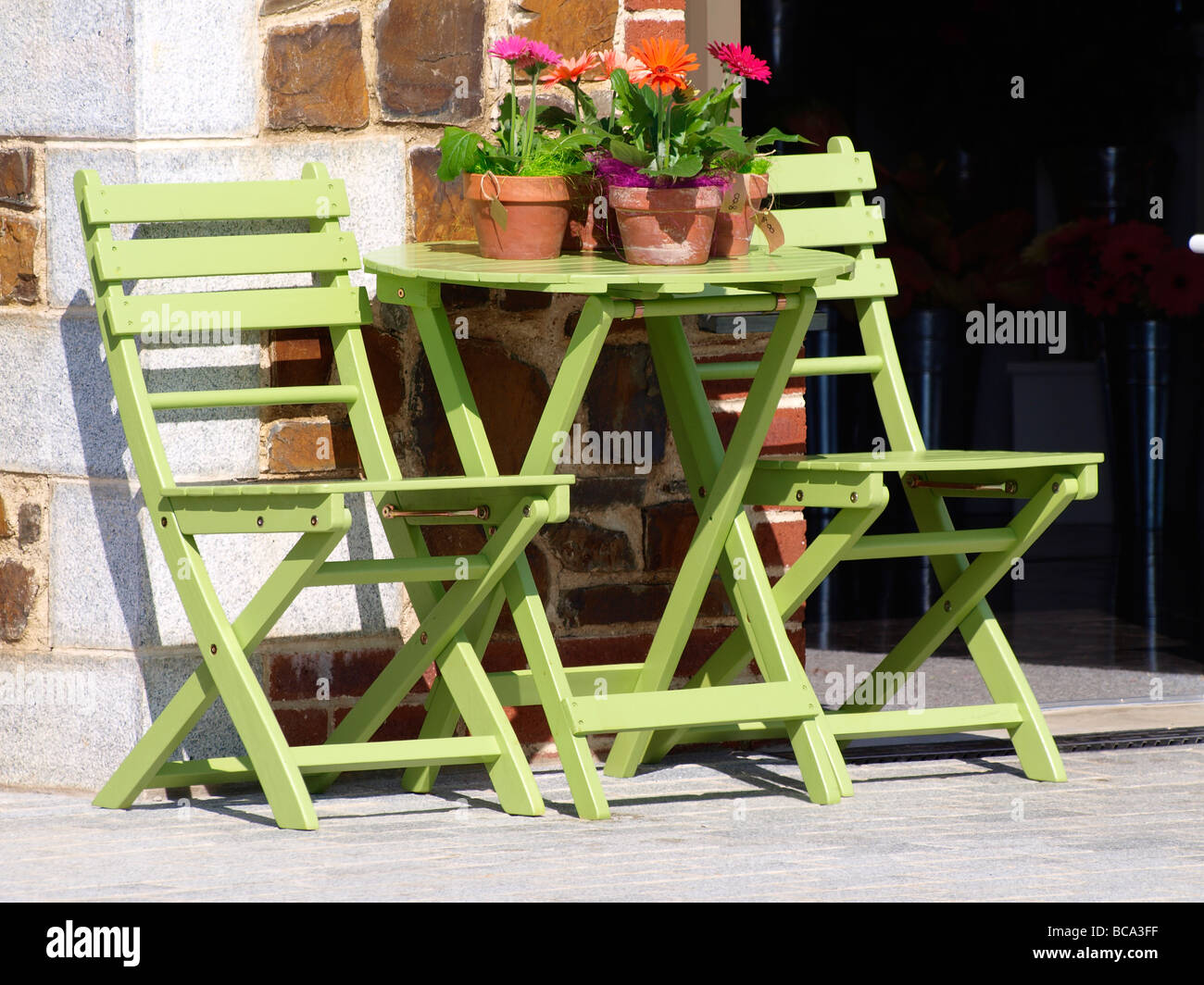 Table and chairs with flowers on Stock Photo - Alamy
