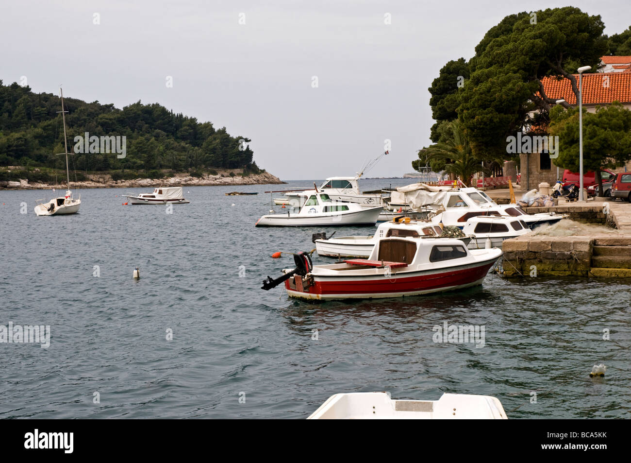 Small pleasure craft moored in front of the church in the pretty ...