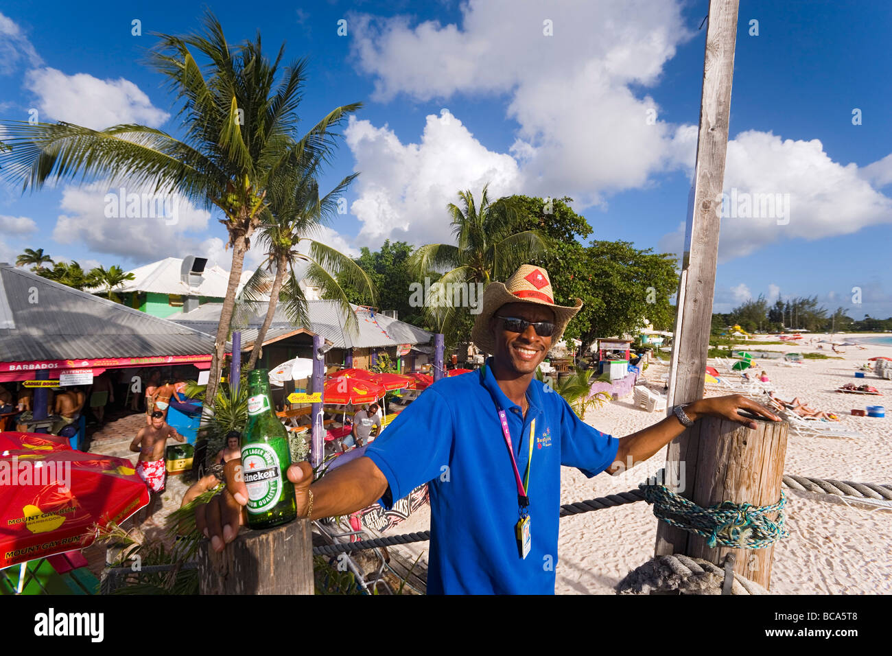 Man smiling at camera, the Boatyard beach bar in background, Bridgetown ...