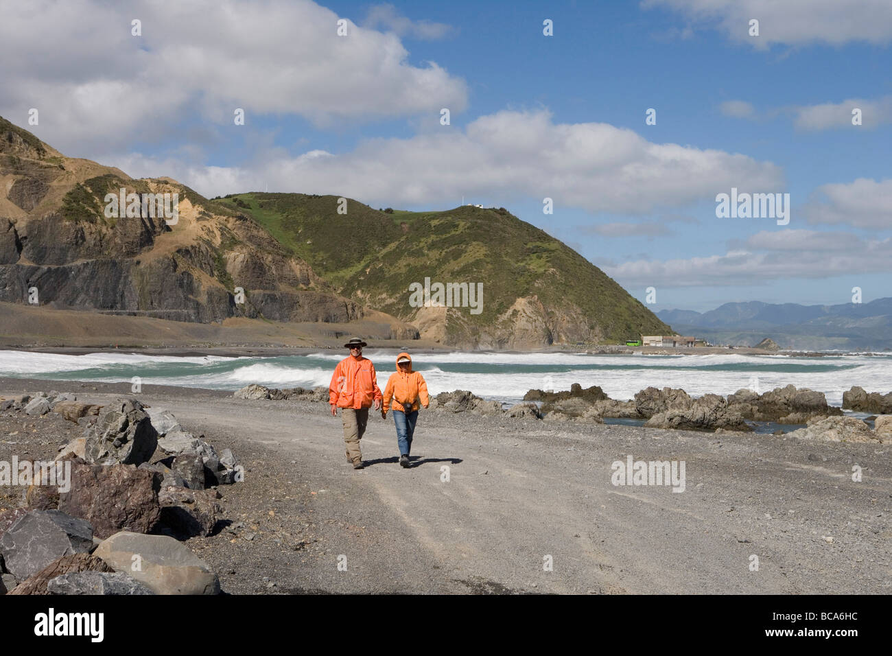 Two Hikers on the Red Rocks Coastal Walk, Owhiro Bay, near Wellington ...