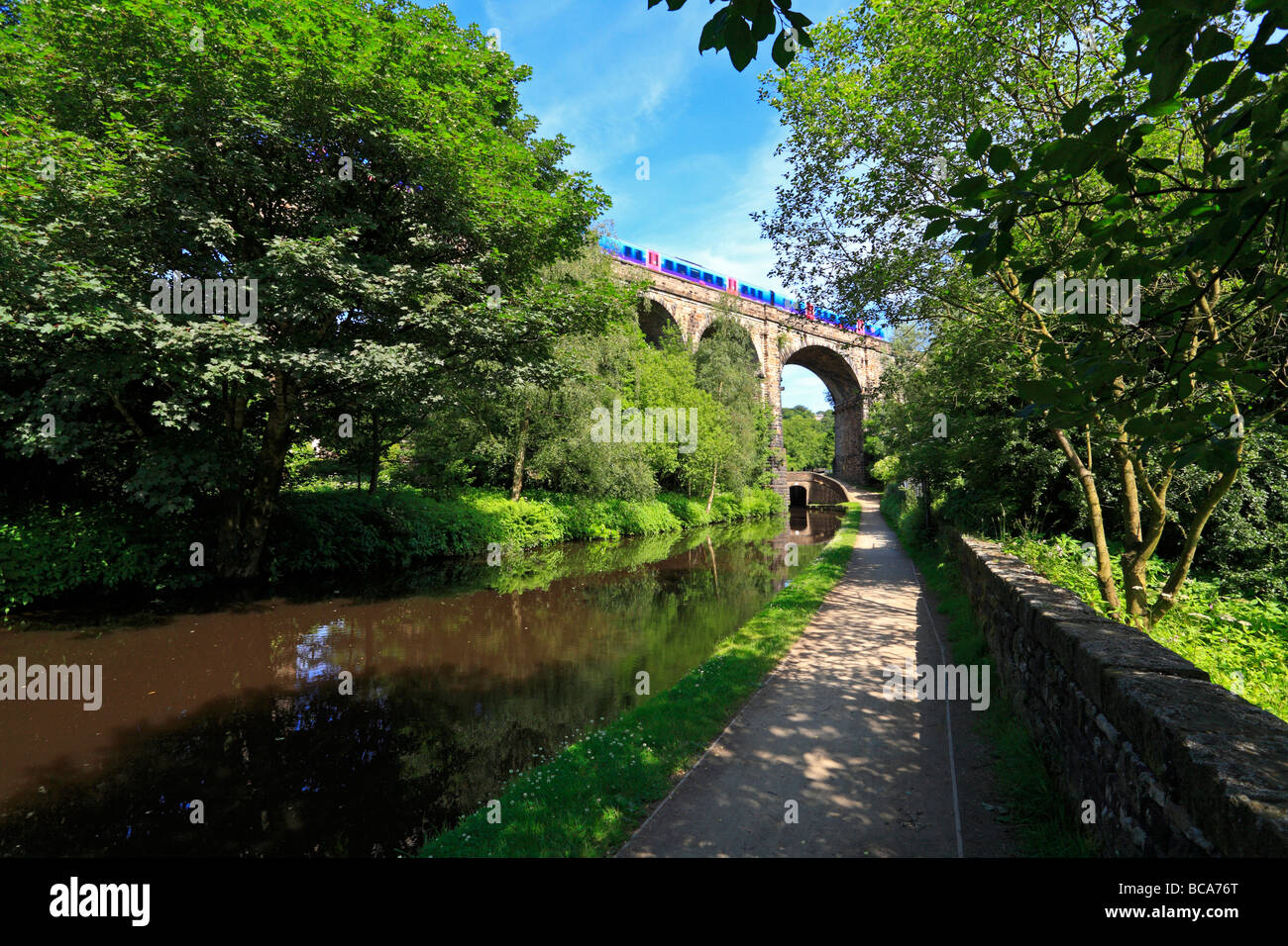 Trans Pennine train on the viaduct at Uppermill, Saddleworth above the ...