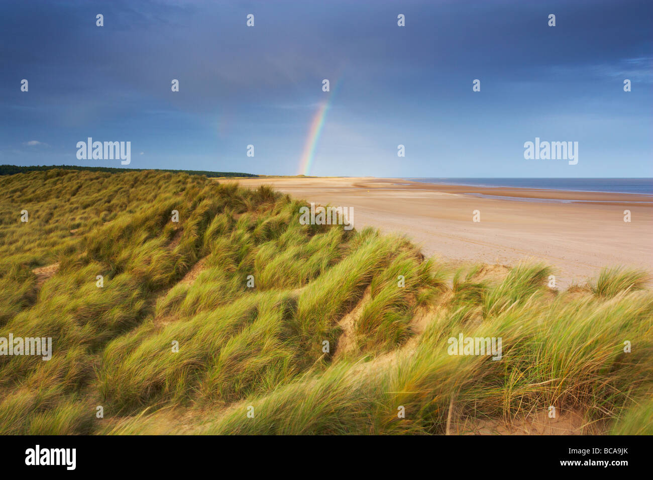 A rainbow over Holkham bay on the North Norfolk Coast Stock Photo - Alamy