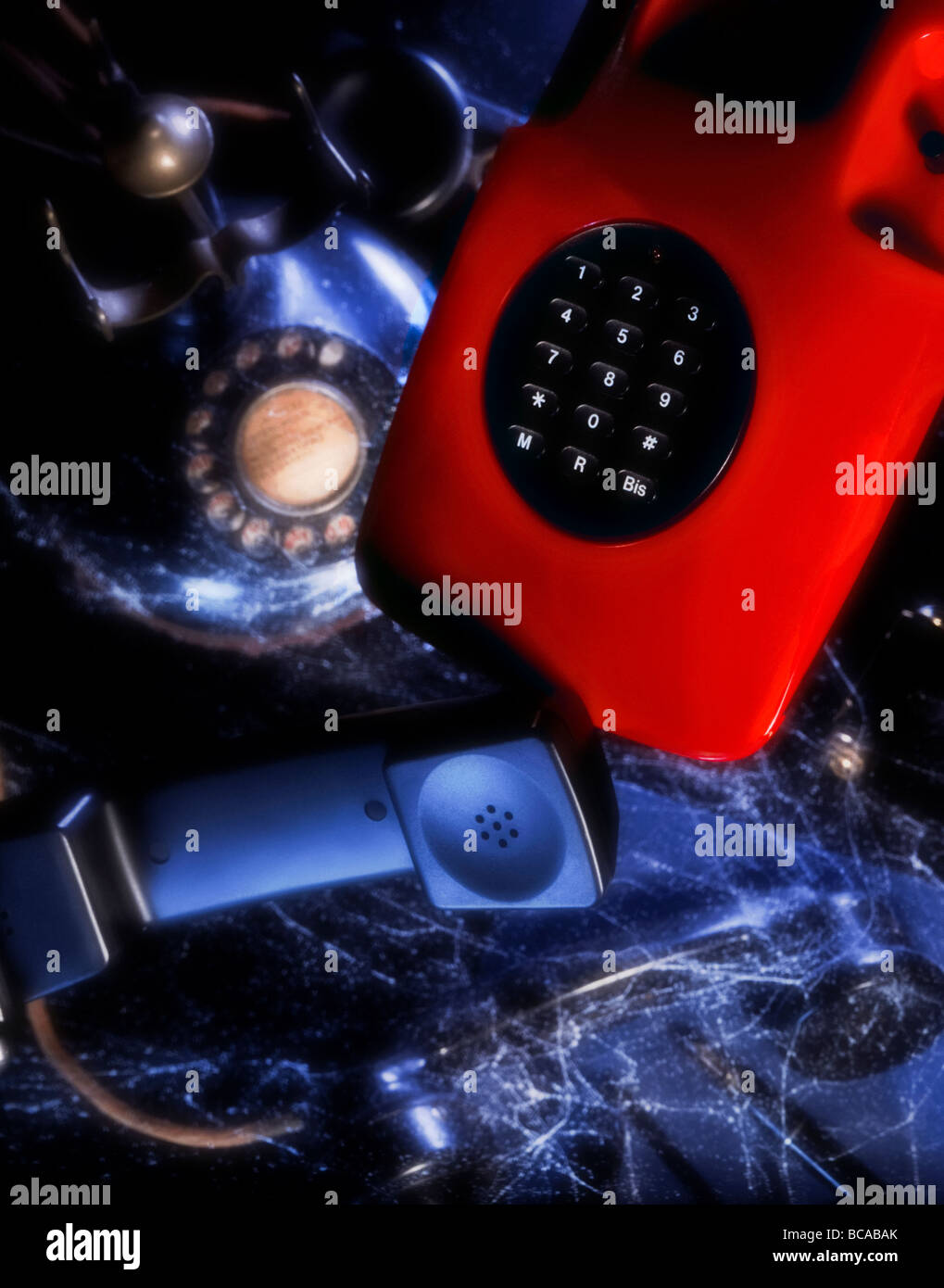 corded telephones red modern versus old bakelite Stock Photo - Alamy