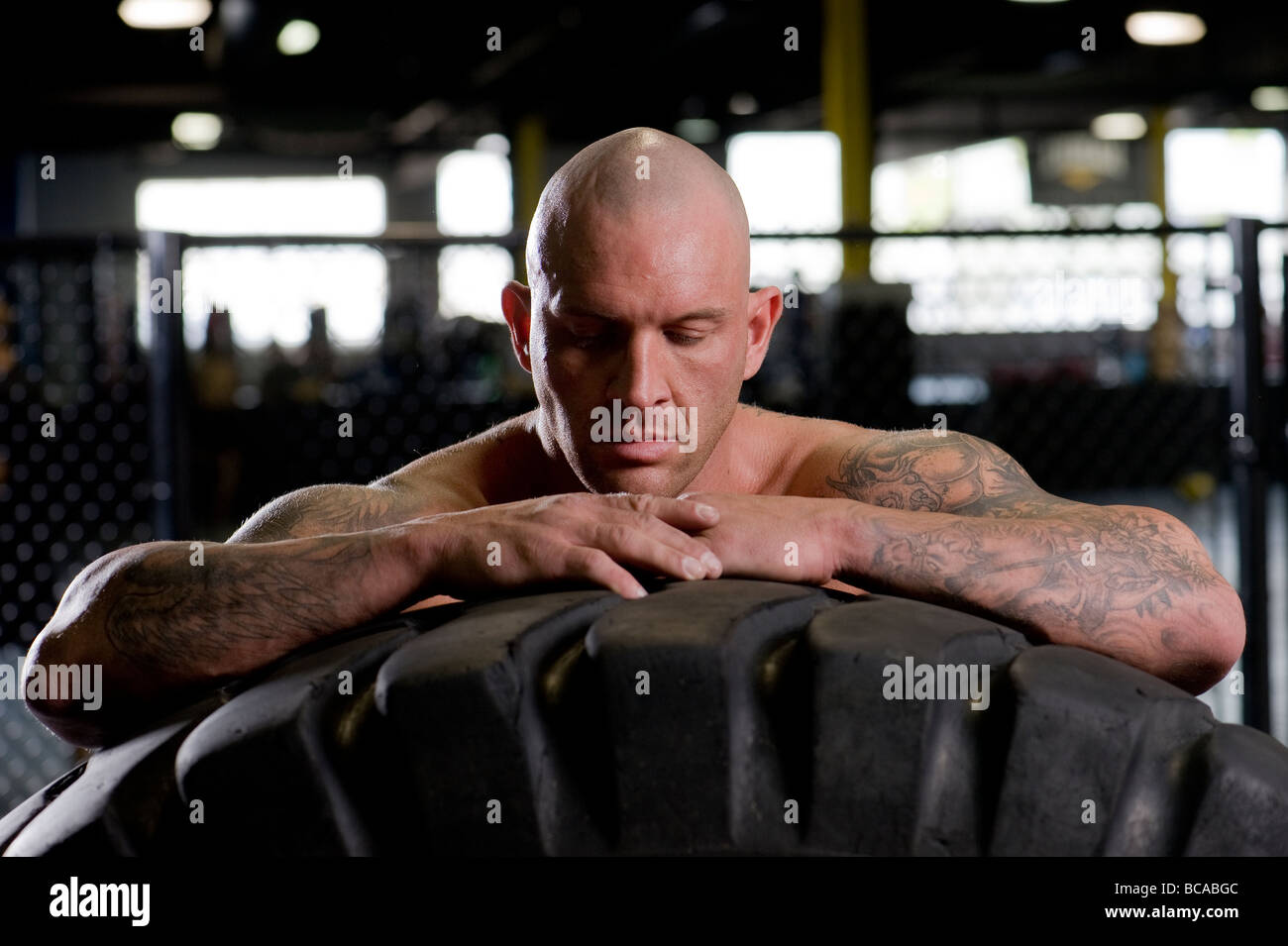 An ultimate fighter trains by tire lifting Stock Photo - Alamy
