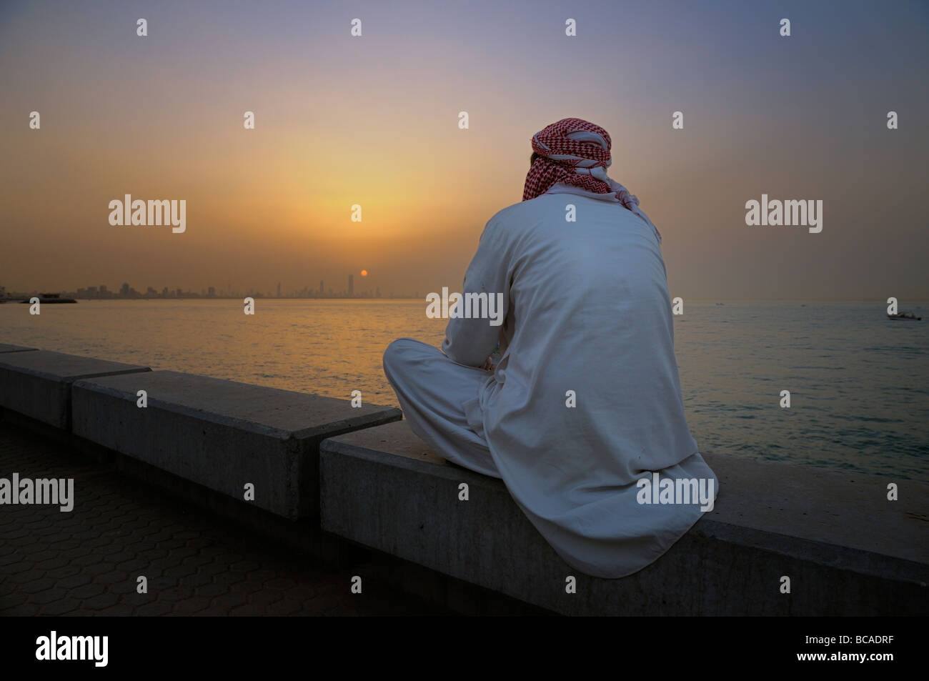 Arab watching sunset Stock Photo - Alamy