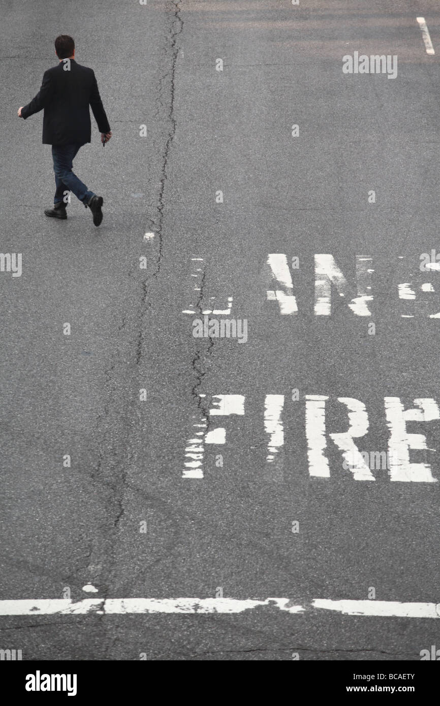 Pedestrian walking across fire lane Stock Photo - Alamy