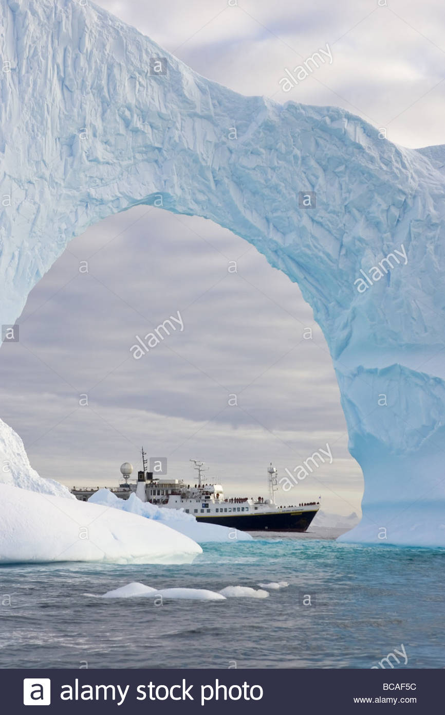 Iceberg and arch, National Geographic Endeavour, Antarctica Stock Photo ...