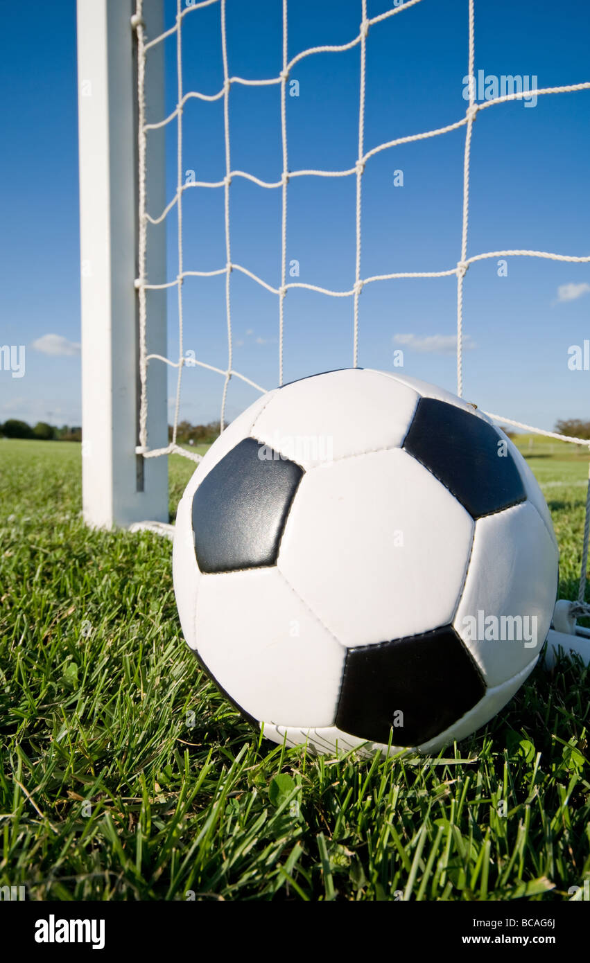 Close up of football in goal net Stock Photo - Alamy