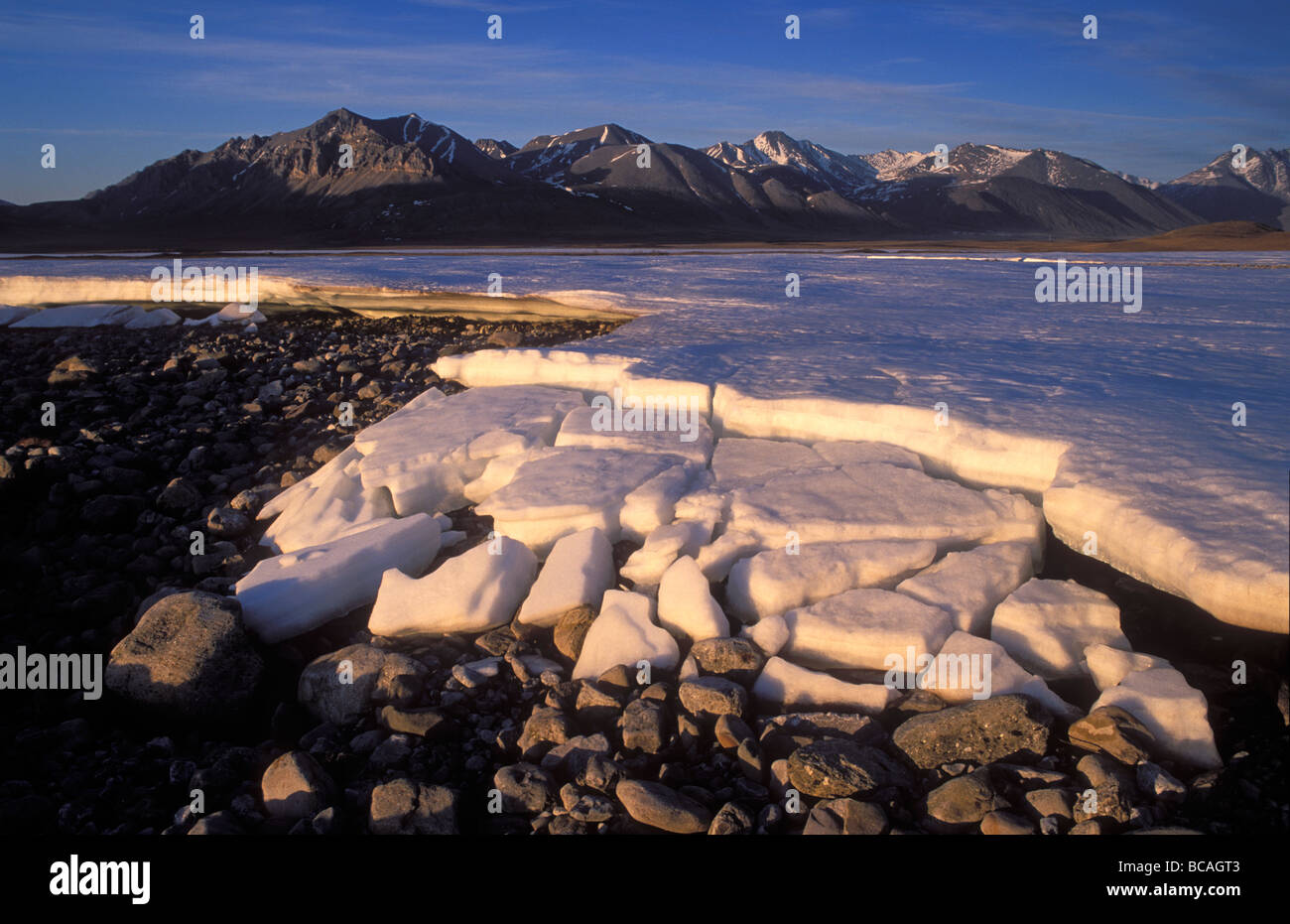 Spring thaw with broken ice and mountains Stock Photo - Alamy